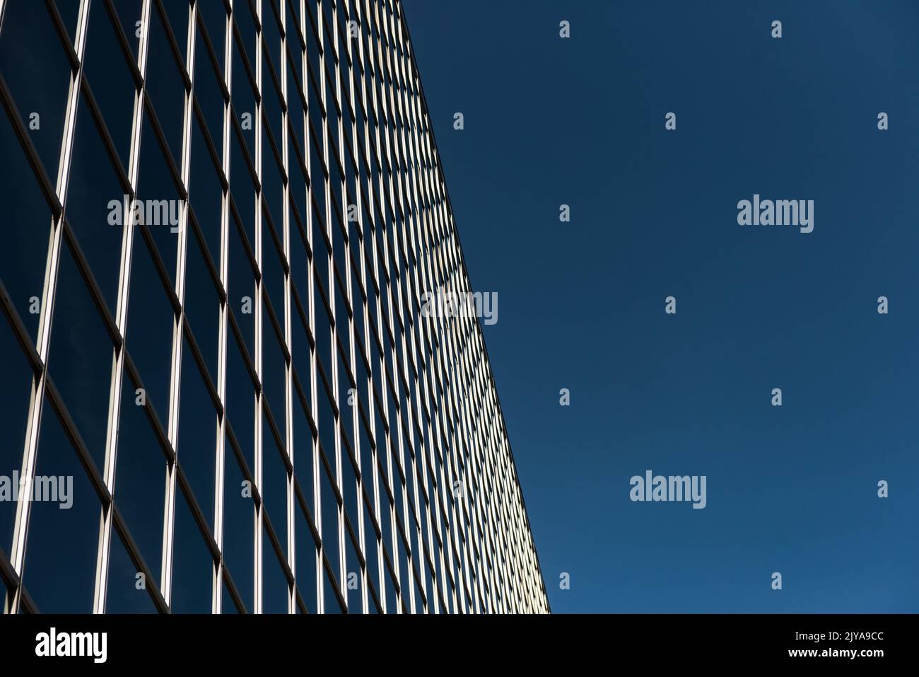 Low angle view of office building against blue sky Stock Photo - Alamy