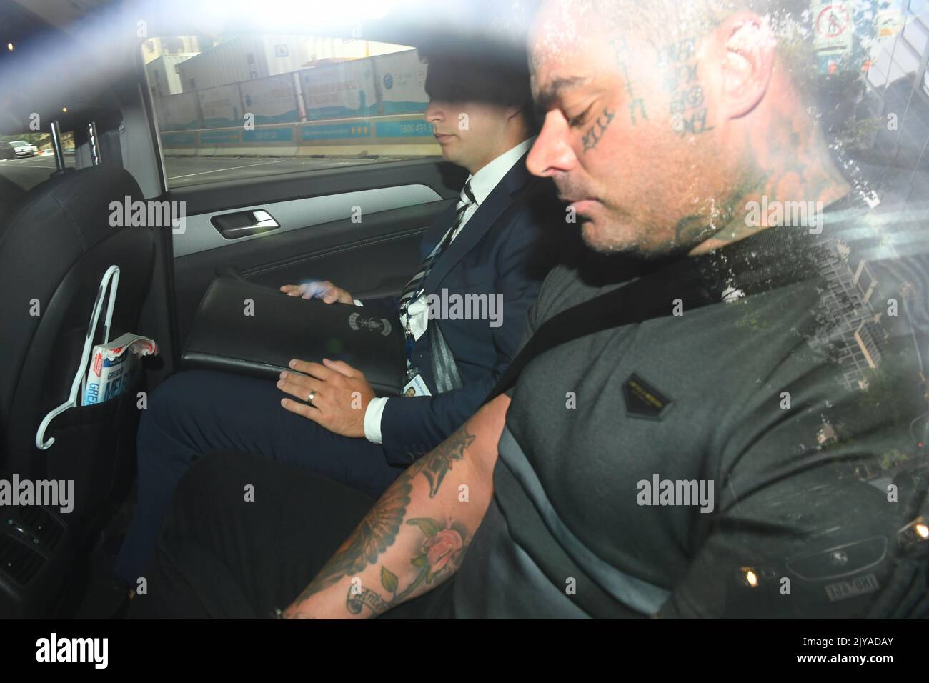 Andrew Heil (right) arrives at the Melbourne Magistrates Court in ...