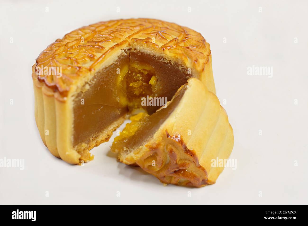 A Chinese mooncake, a round pastry about 4inch in diameter and 1.5inch ...