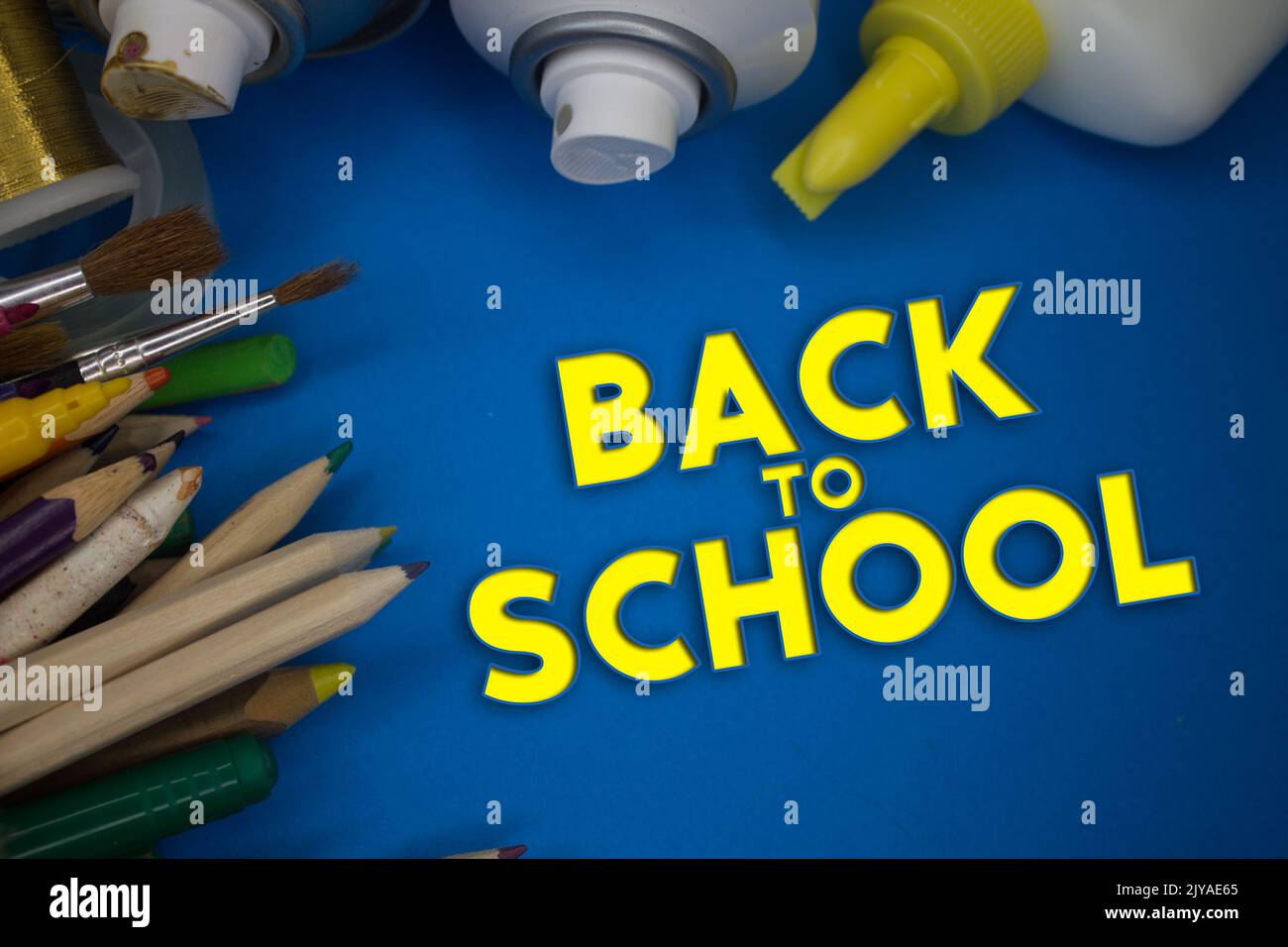 Overhead shot of school supplies with Back to School text. Brushes ...