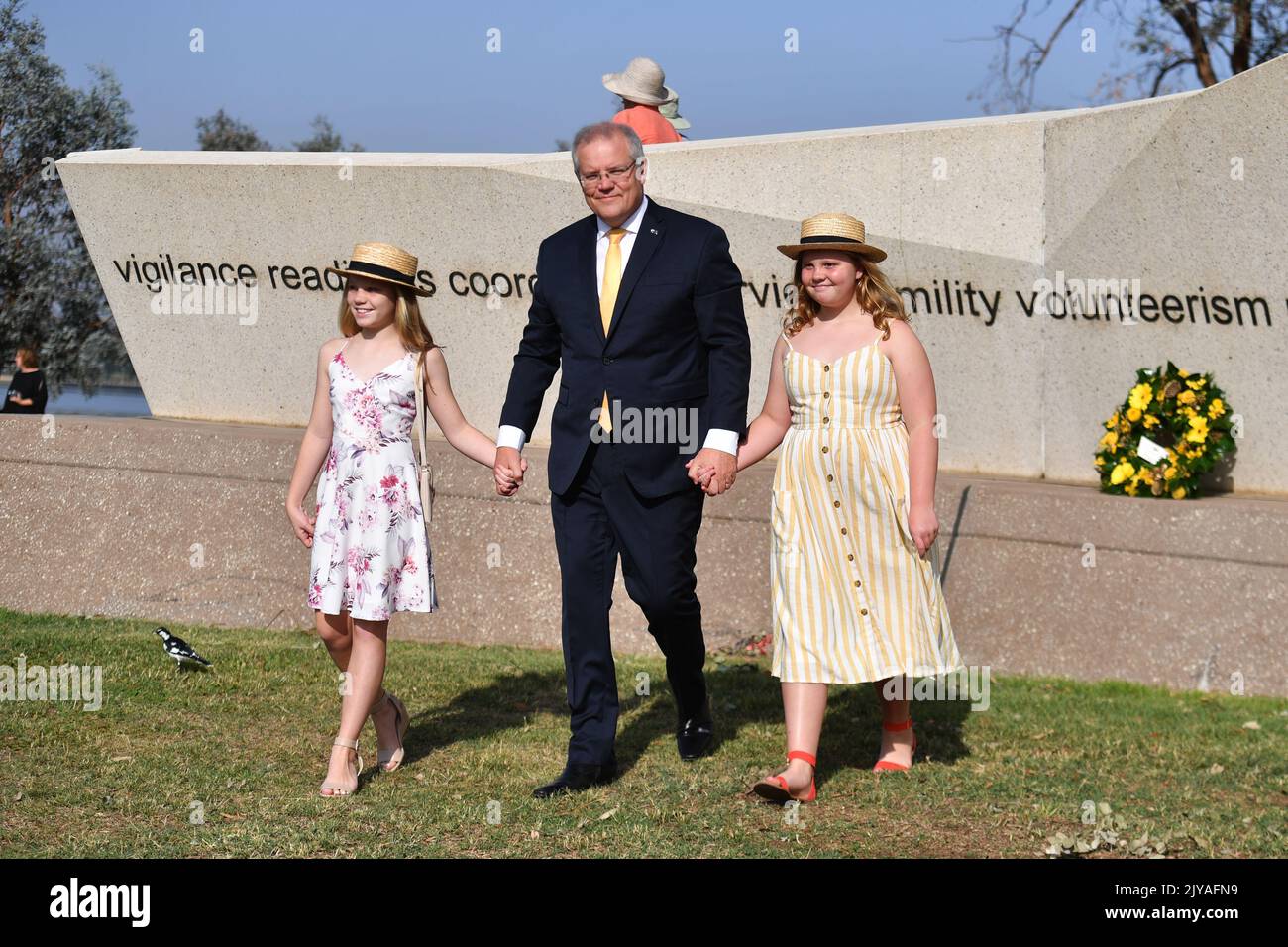 Prime Minister Scott Morrison and daughters Abbey and Lily lay a wreath ...