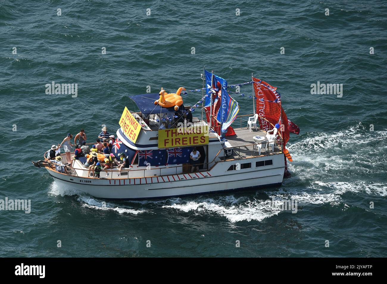A boat decorated with Australian flags and a thank you message for fire ...