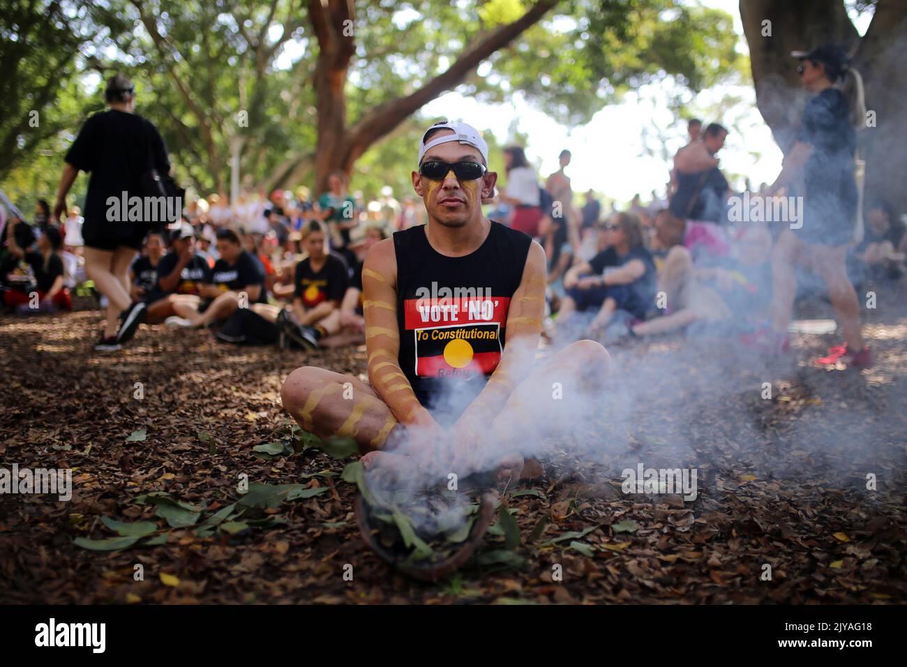 A protestor performs a smoking ceremony during an Invasion Day rally in ...