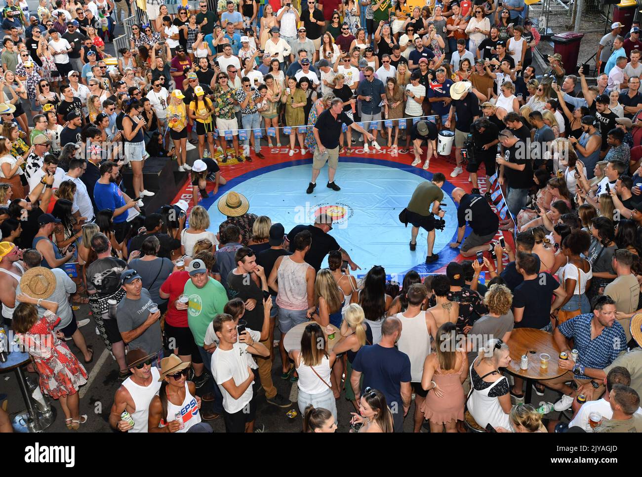 People are seen watching the cockroach races during Australia Day ...
