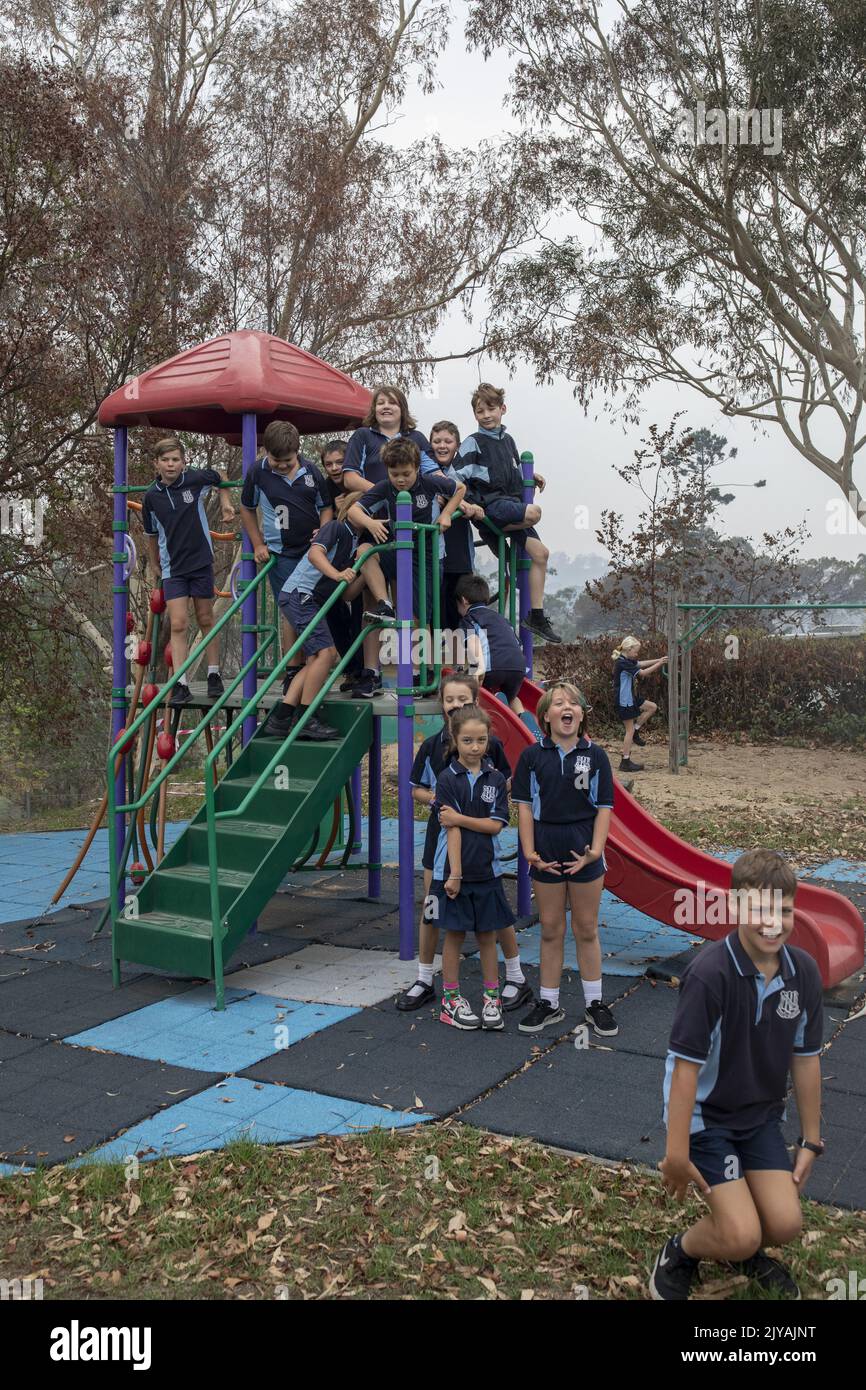 Students play in the playground on the first day of school in Cobargo ...