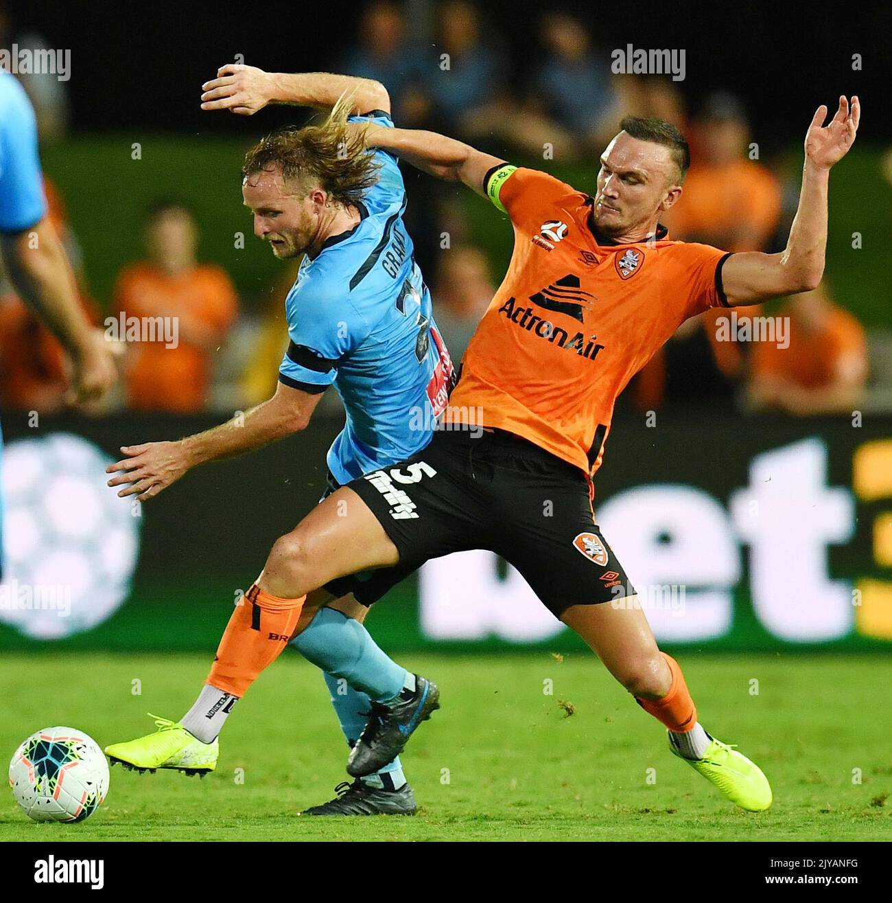 Tom Aldred of the Roar tackles Sydney's Rhyan Grant during the Round 17 ...