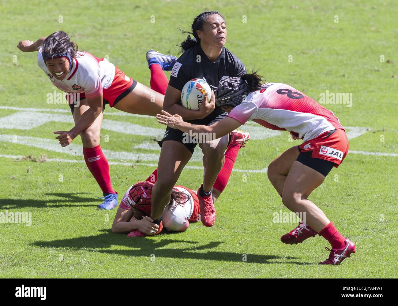 Alena Saili of New Zealand is tackled by Japanese women during day one ...