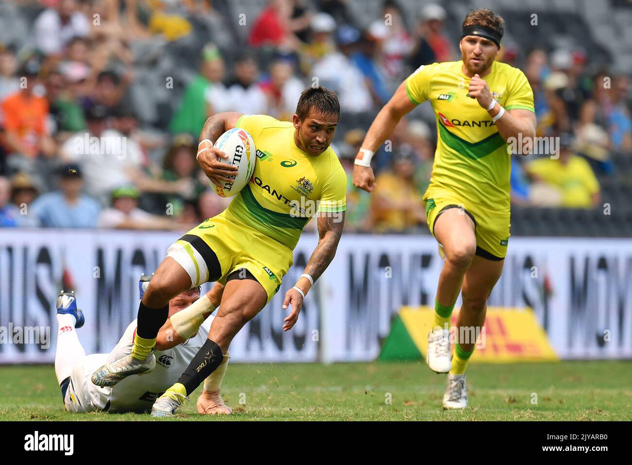 Maurice Longbottom of Australia is tackled by Steve Tomasin of the USA ...