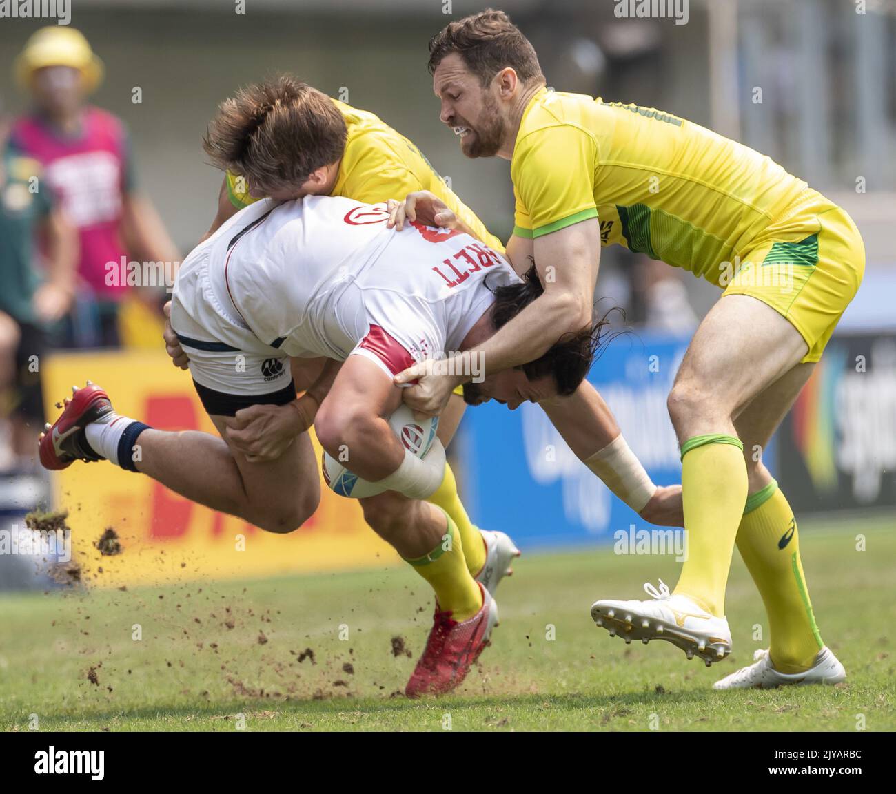 Lewis Holland of Australia tackles Steve Tomasin of the USA during day ...