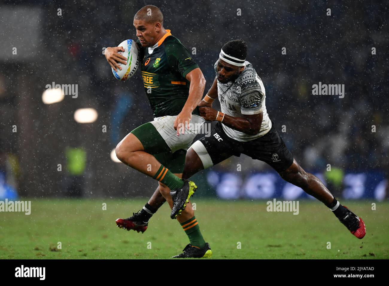 Zain Davids of South Africa is tackled by Vilimoni Botitu of Fiji the ...