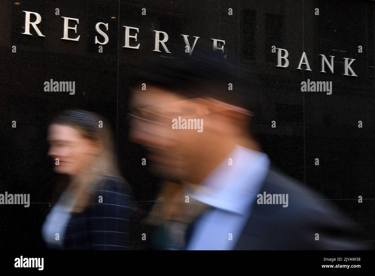 Pedestrians walk past the Reserve Bank of Australia (RBA) building in ...