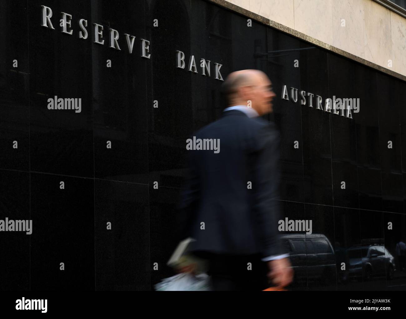 A pedestrian walks past the Reserve Bank of Australia (RBA) building in ...