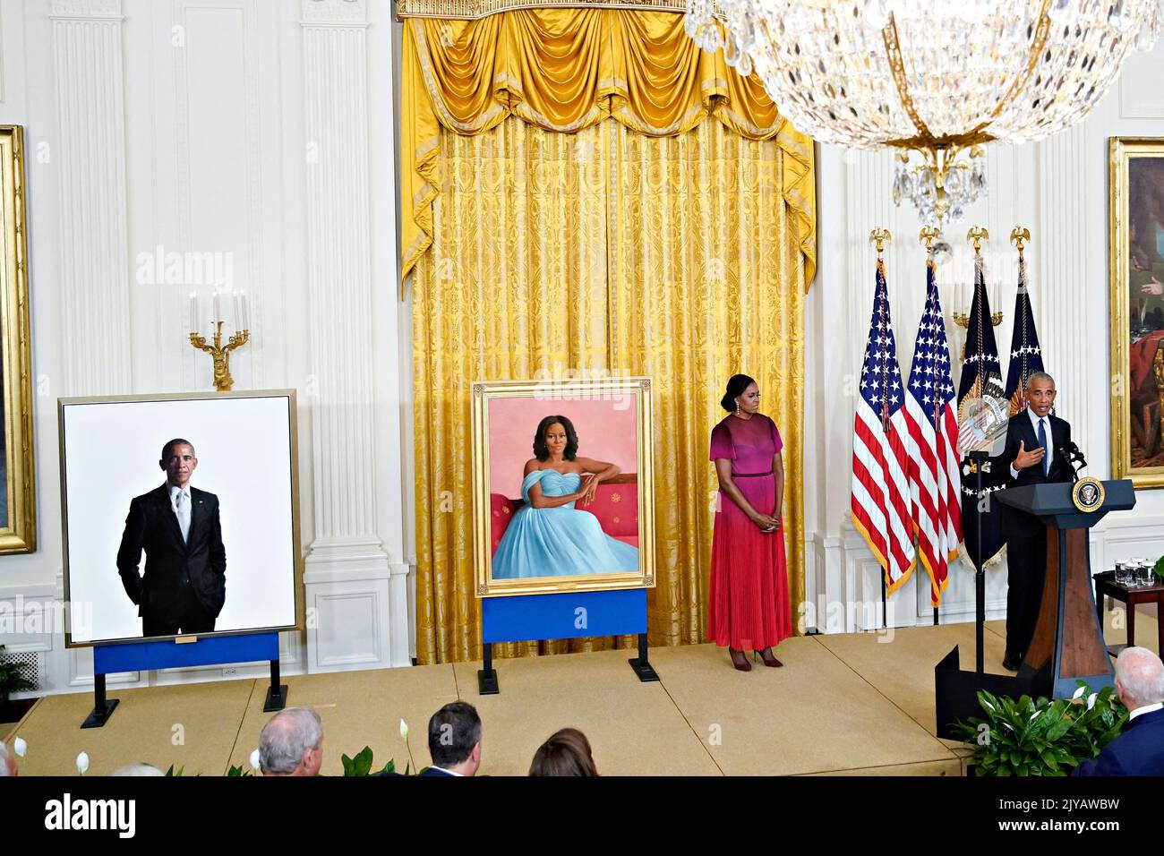 Former US President Barack Obama, right, speaks as former First Lady Michelle Obama, center ...
