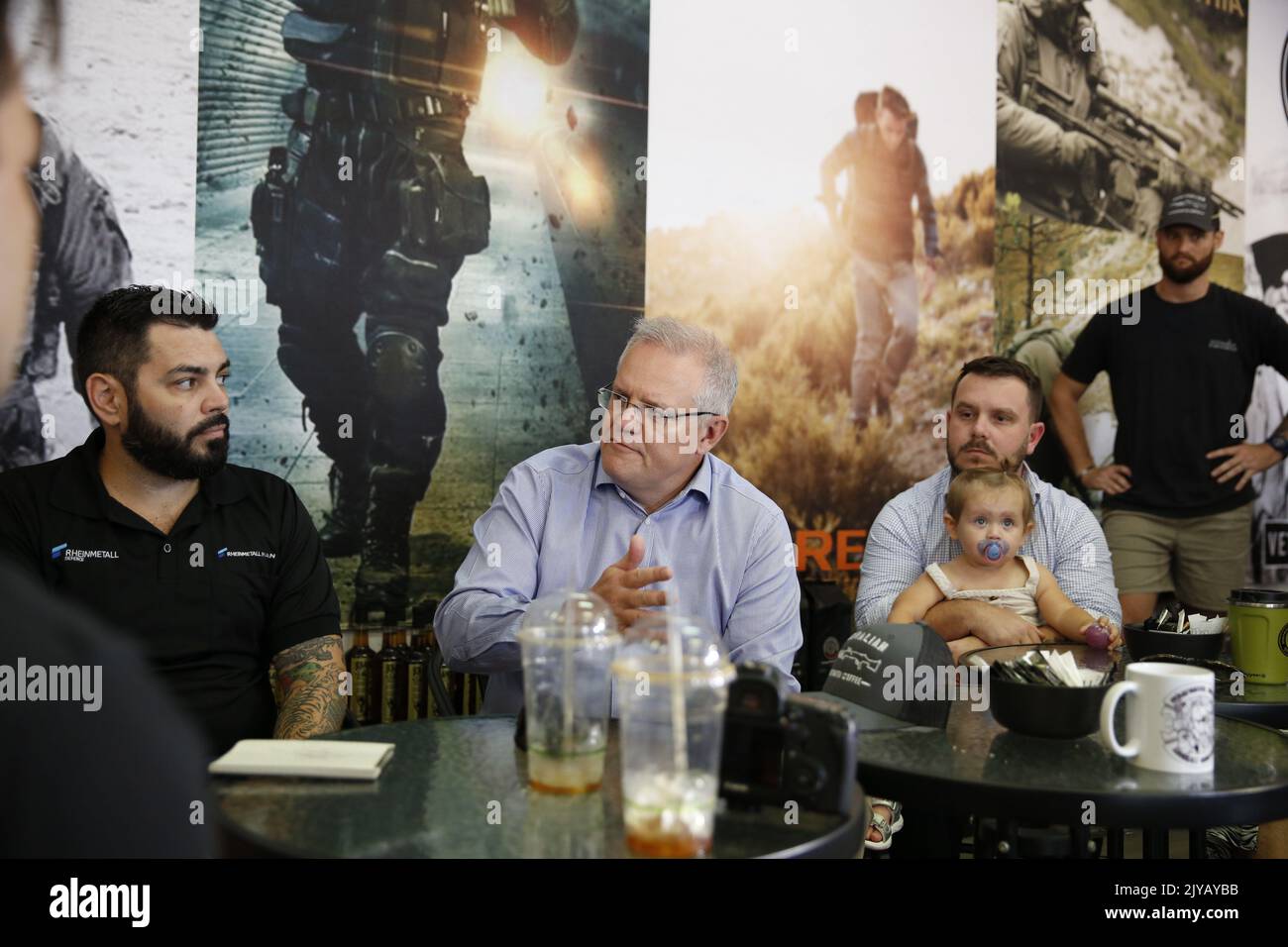 Prime Minister Scott Morrison (centre) speaks to veteran Paul Warren ...