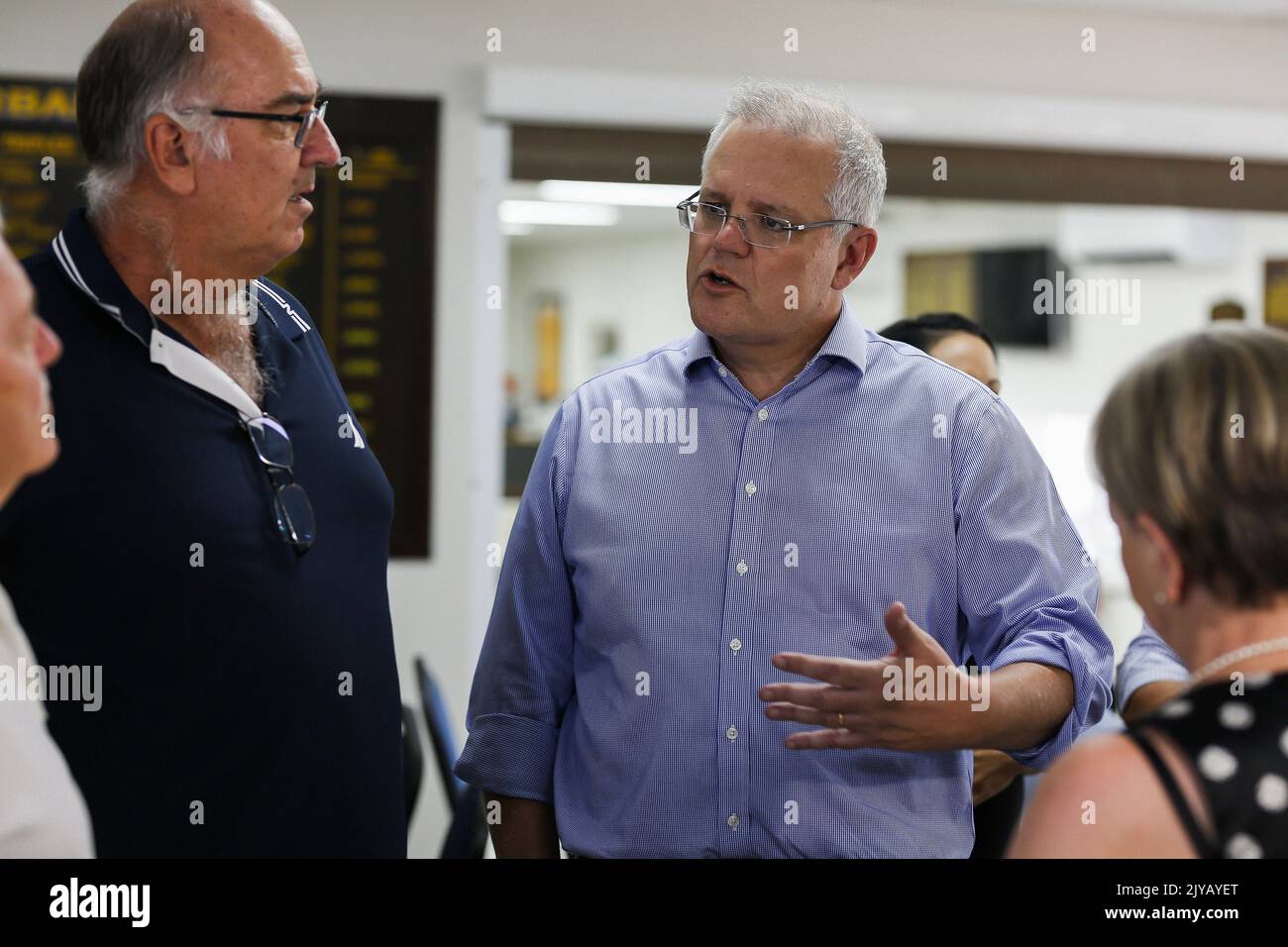 Prime Minister Scott Morrison (centre) speaks with Jim Casper during a visit to the Suburban ...