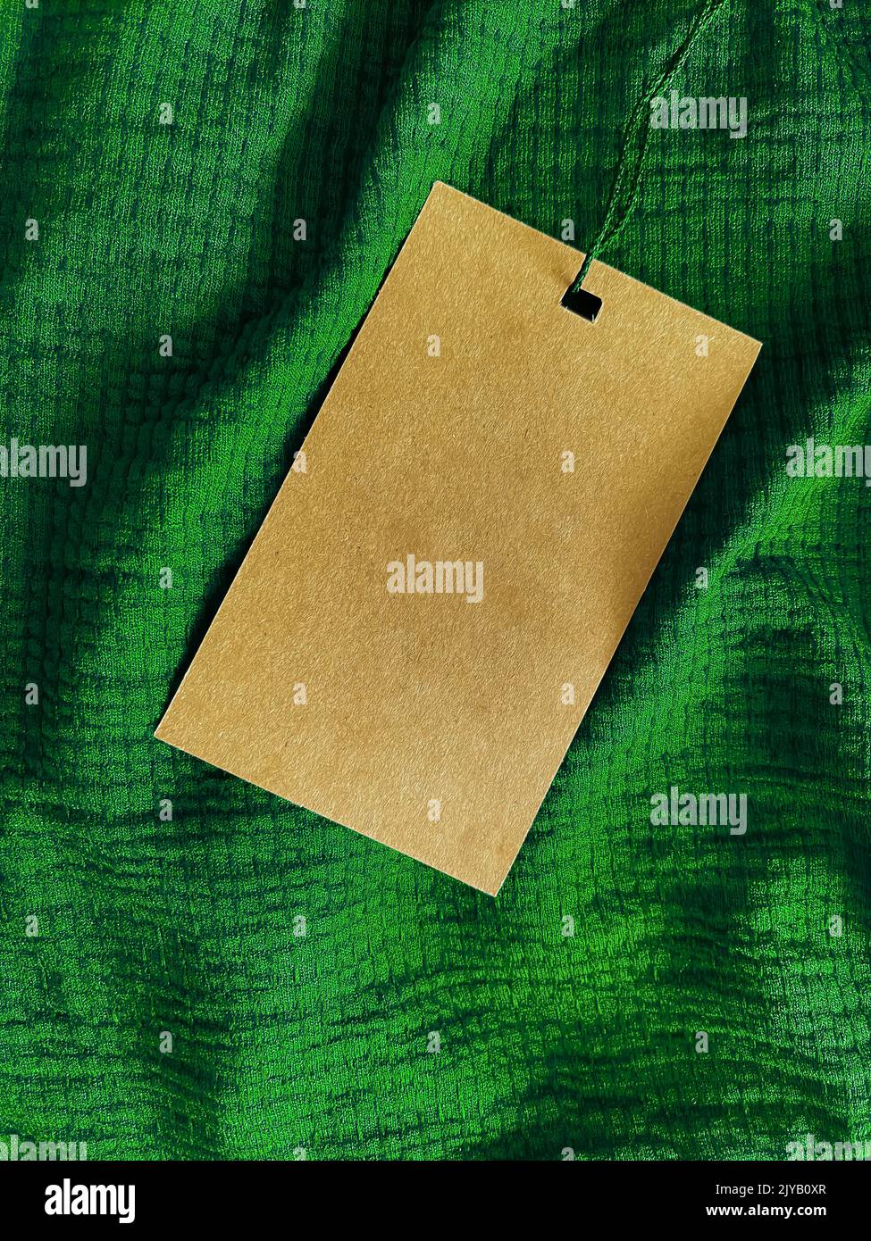Blank fashion label tag, sale price card on luxury fabric background ...