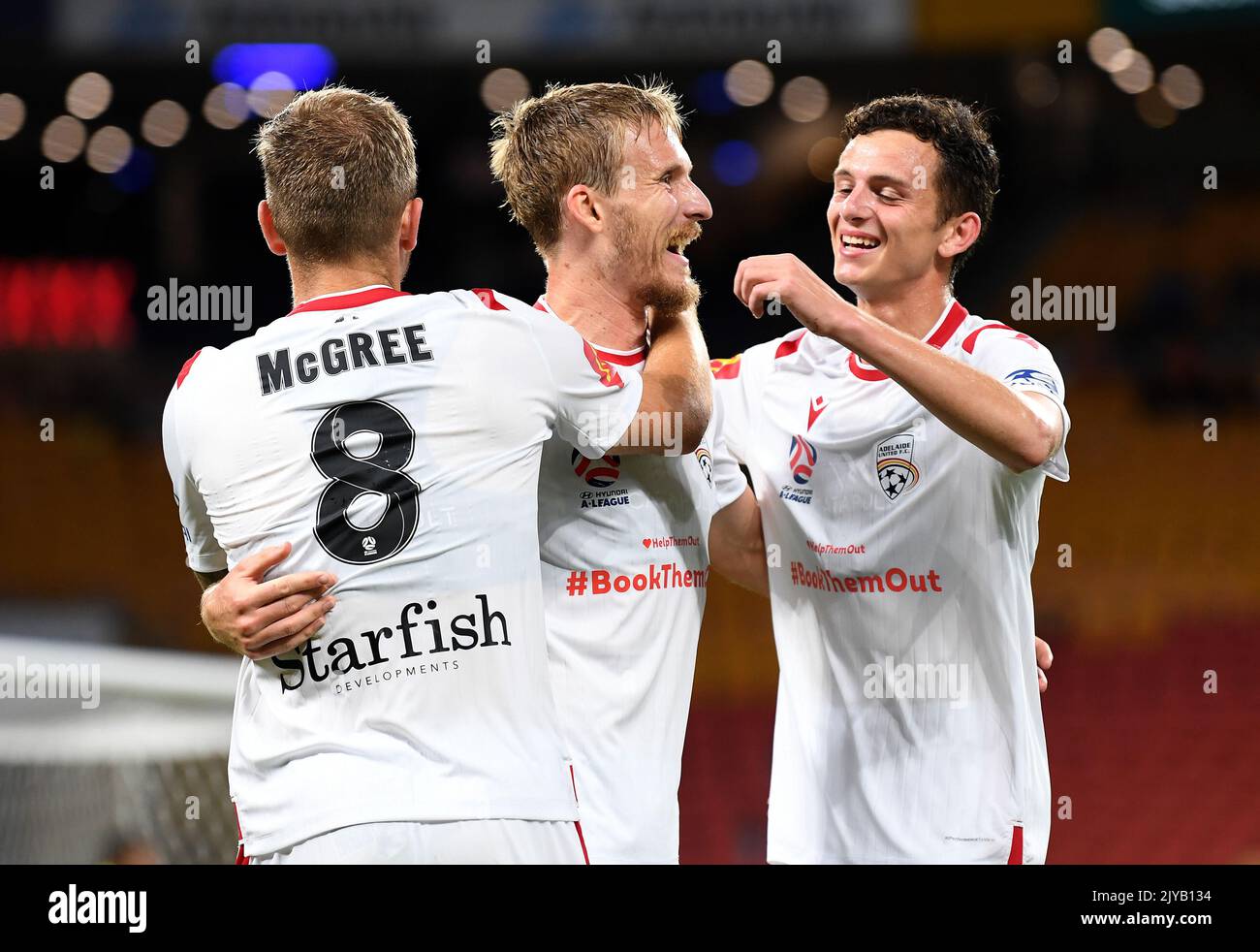 Benjamin Halloran of Adelaide United (centre) celebrates scoring a goal ...