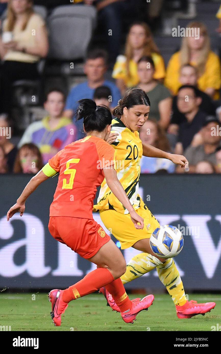 Sam Kerr of Australia comes under pressure from Wu Haiyan of China ...