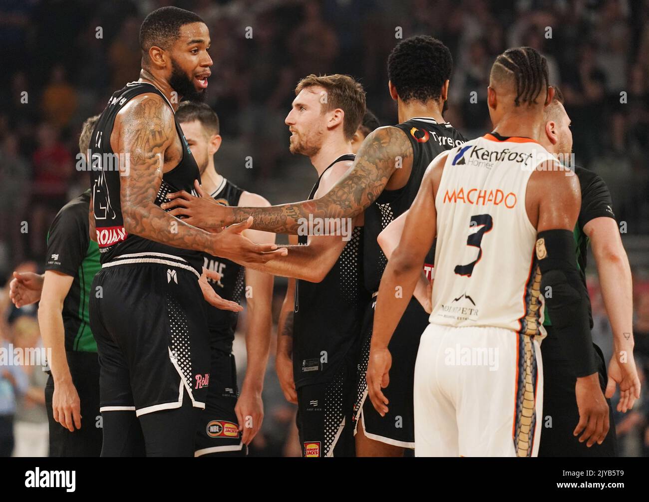 Shaun Long of United (left) reacts to Scott Machado of the Taipans ...