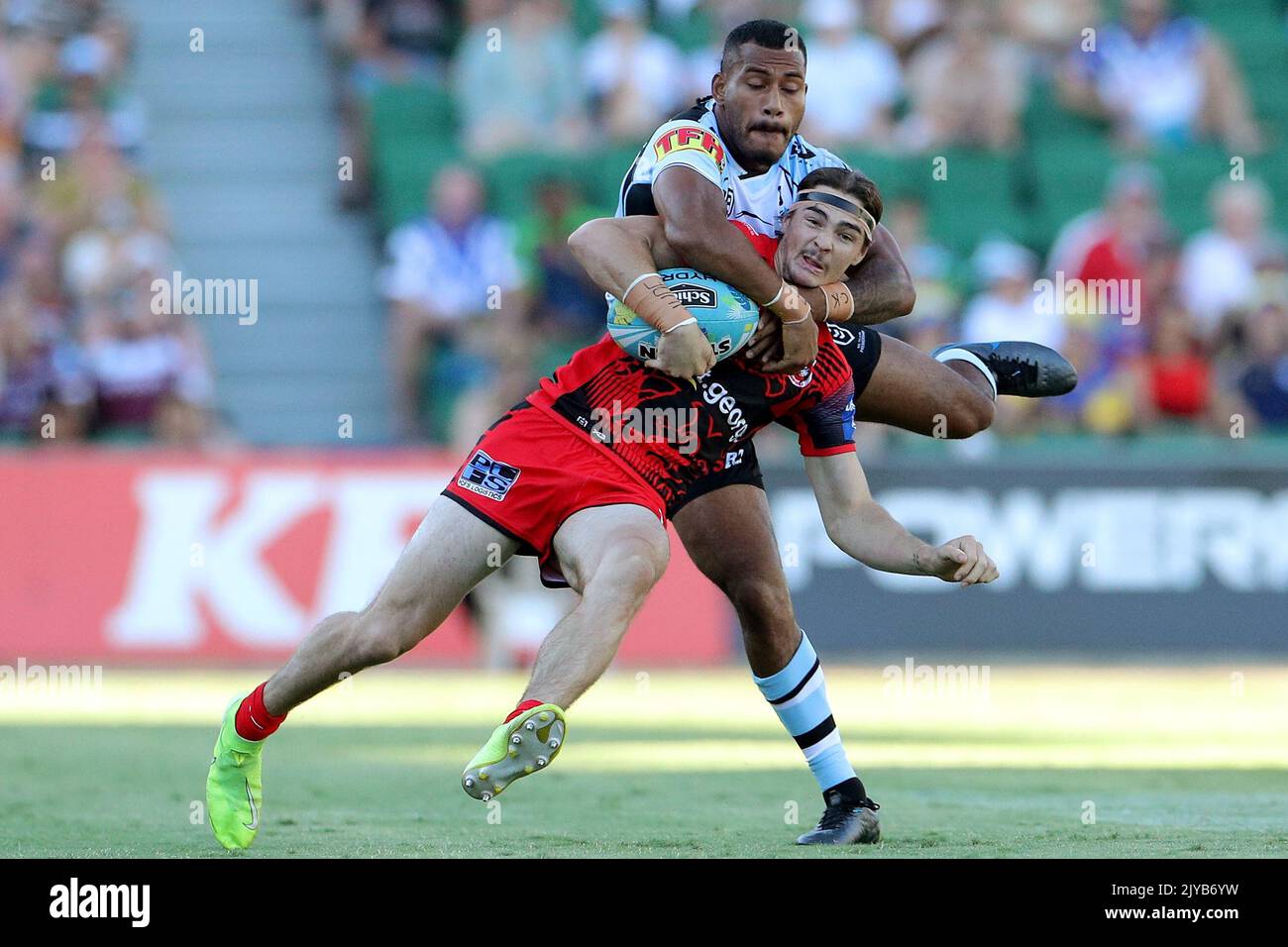 Cody Ramsey of the Dragons is tackled by Blayke Brailey of the Sharks ...