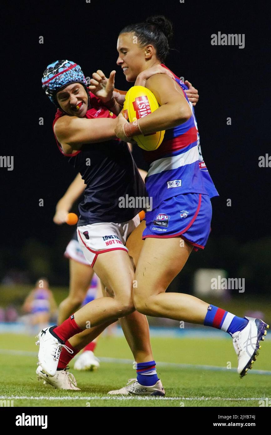 Aliesha Newman of the Demons tackles Bailey Hunt of the Bulldogs during ...