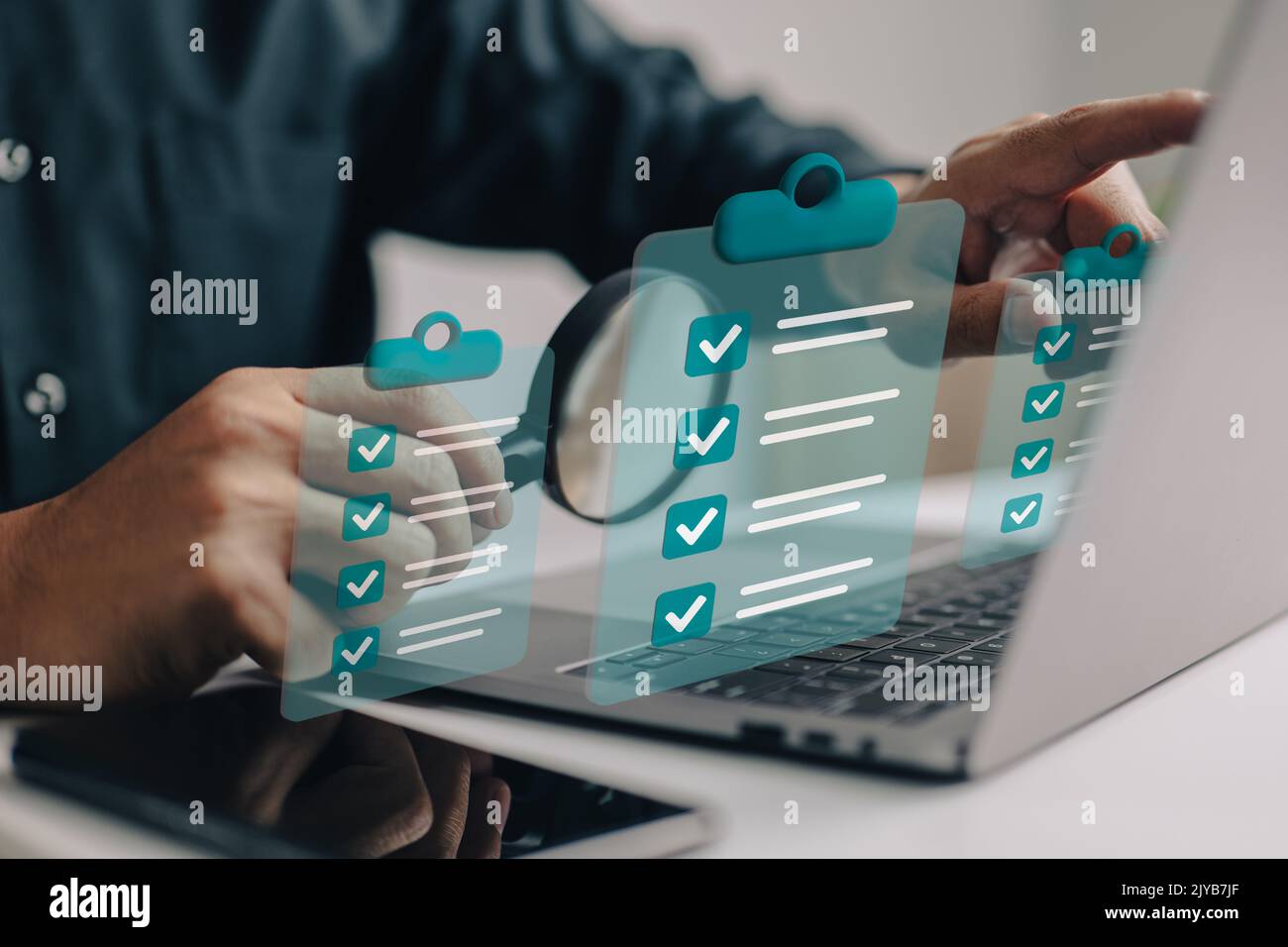 Businessman use magnifying glass with a checklist on clipboard paper ...