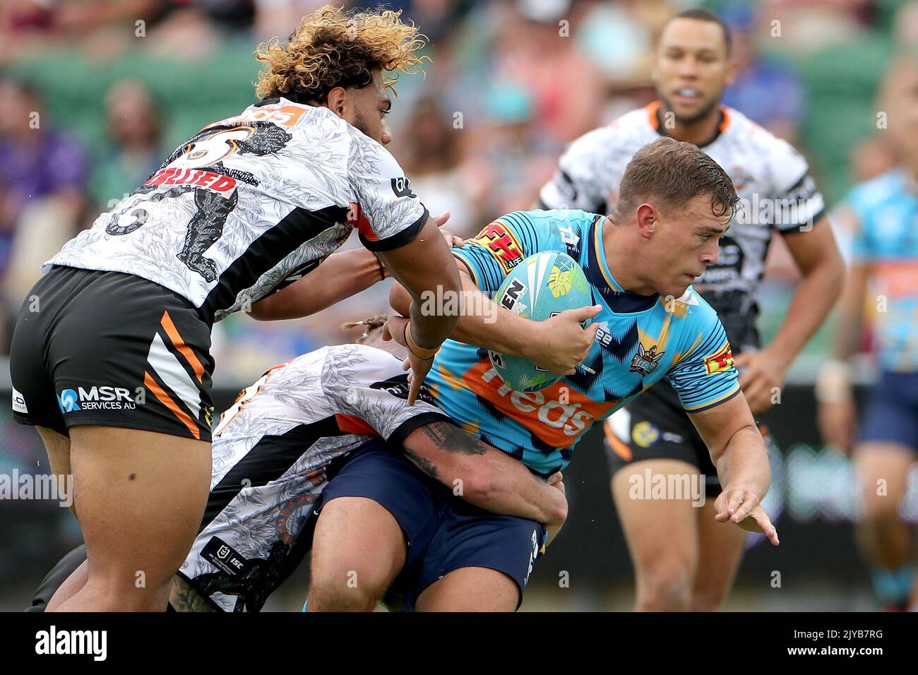 Jai Whitbread of the Titans pushes to score a try during the NRL Nines ...