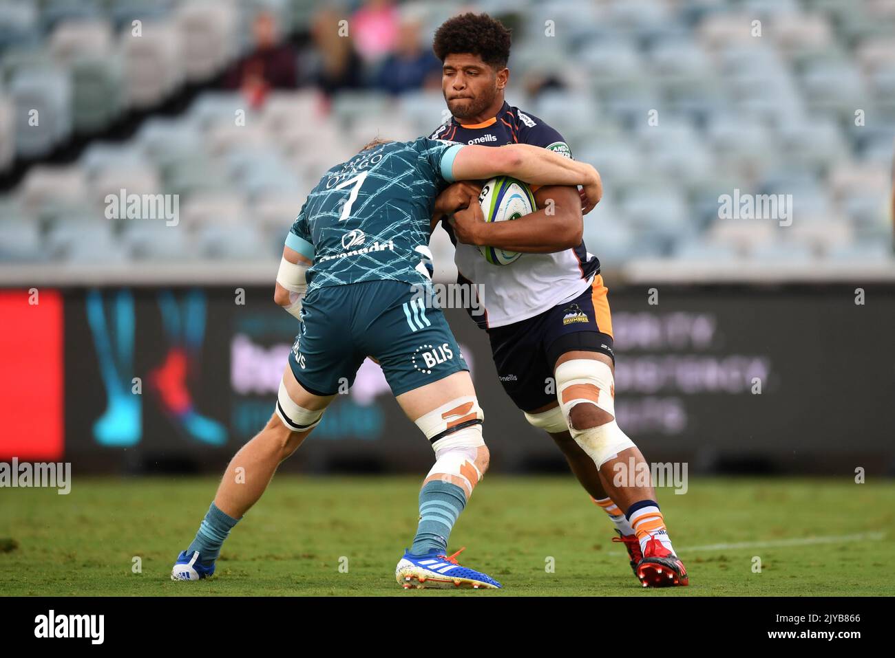 Robbie Valentini of the Brumbies (right) is tackled by James Lentjes of ...