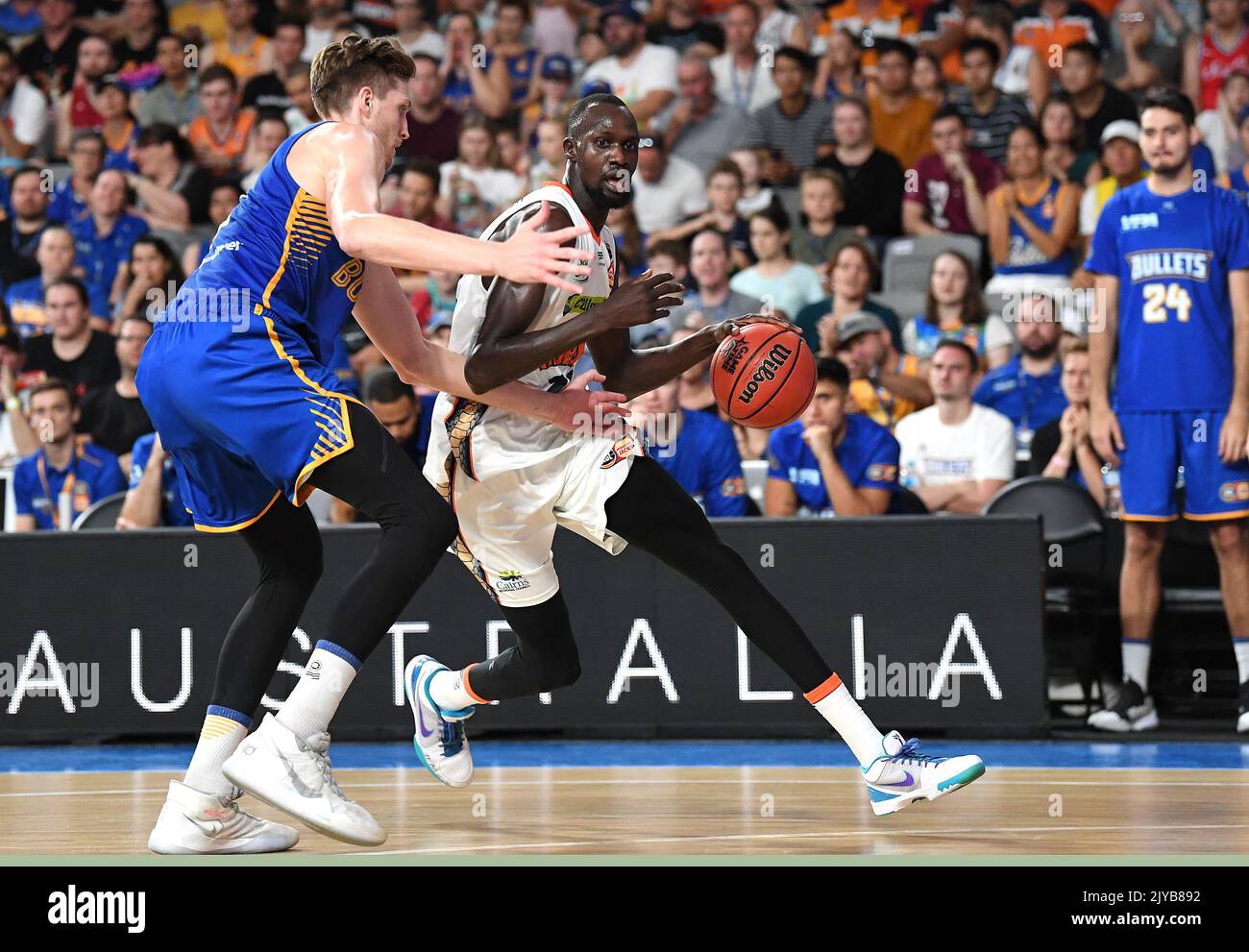 Majok Deng of the Taipans (right) goes around Matthew Hodgson of the ...