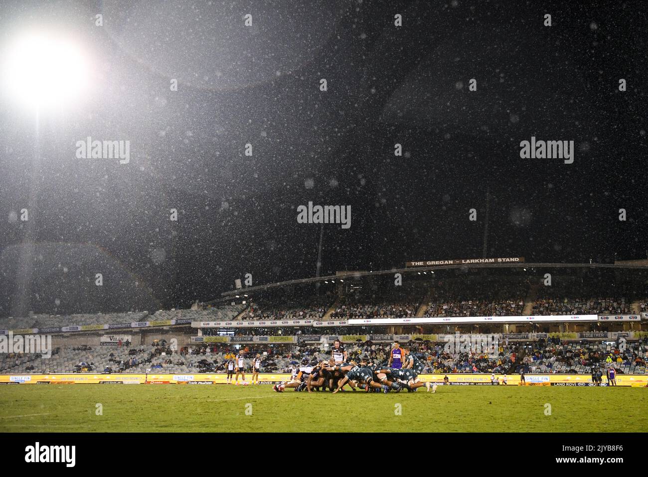 Players are seen forming a scum under heavy rain during the Round 3 ...