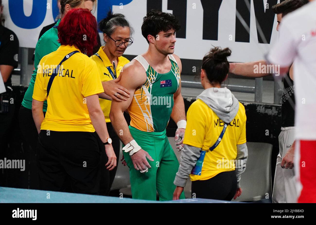 Clay Mason Stephens of Australia is helped by officials after injuring ...