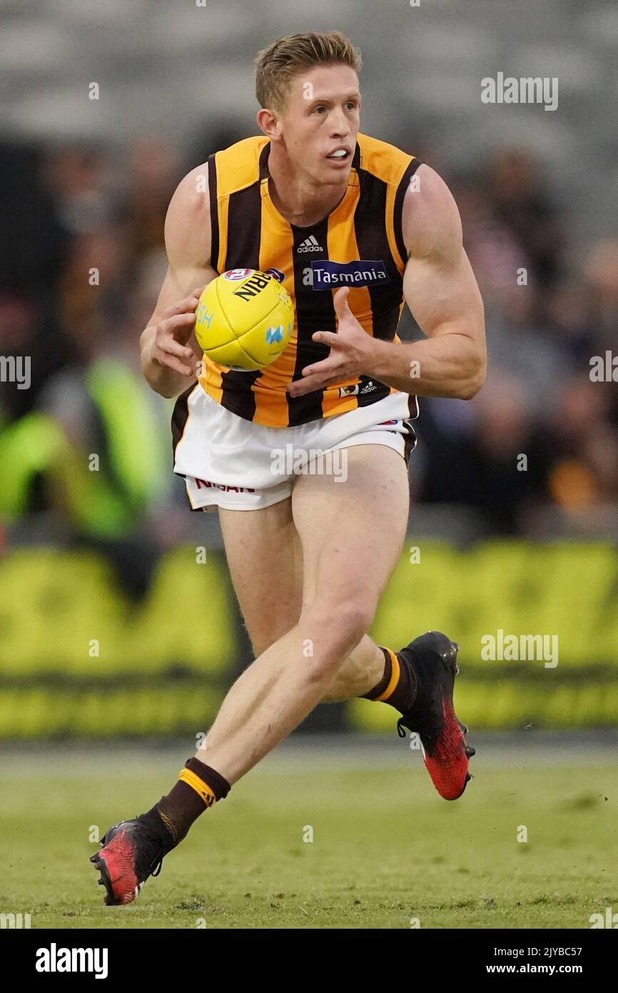 Sam Frost of the Hawks runs with the ball during the AFL Marsh ...
