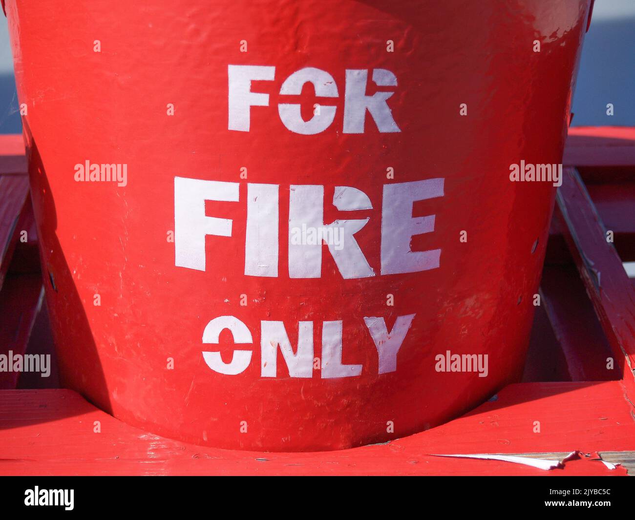 Bright red buckets labeled in white For Fire Only ready as protection ...