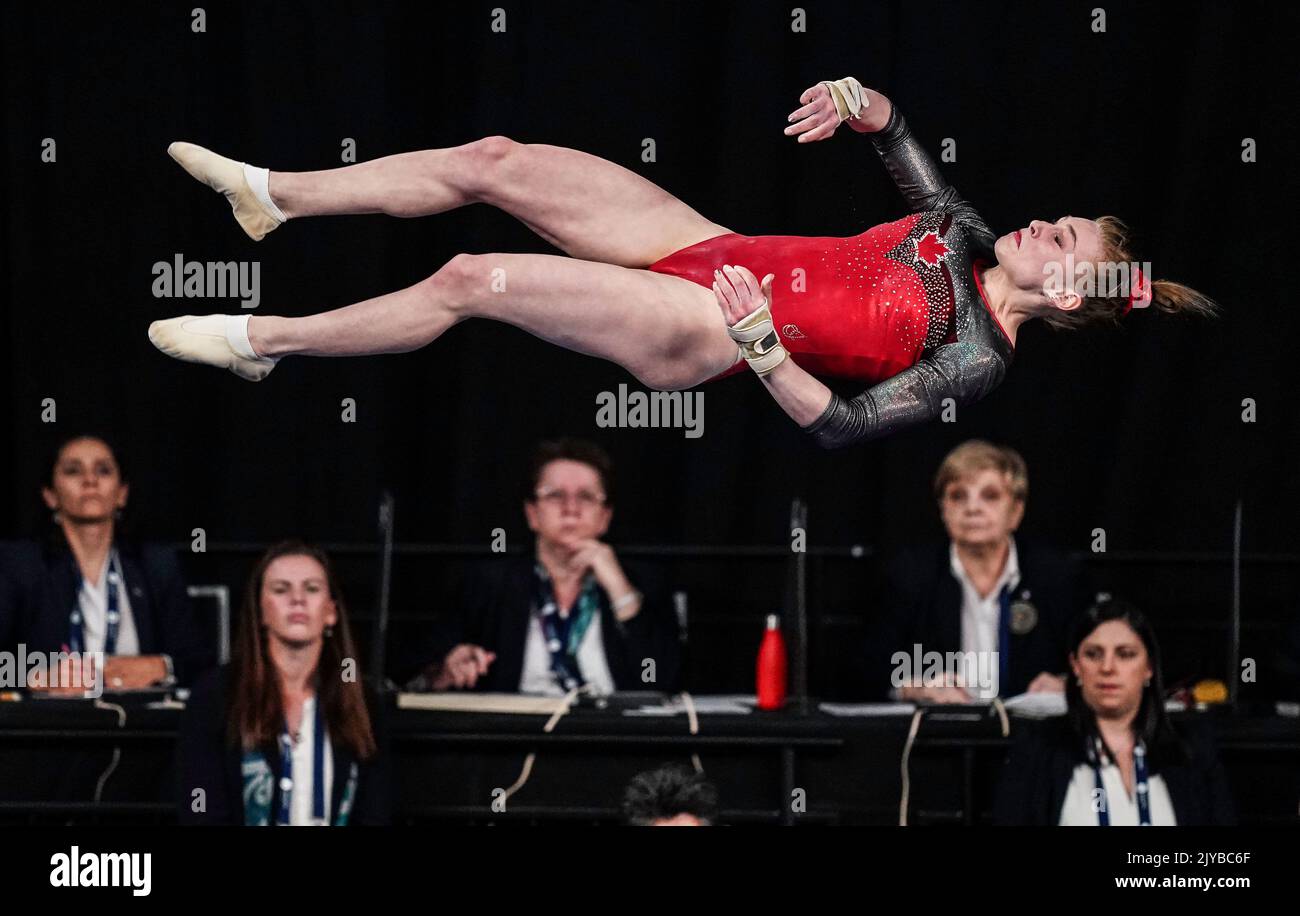 Emma Spence of Canada performs on the vault as the judges watch during ...