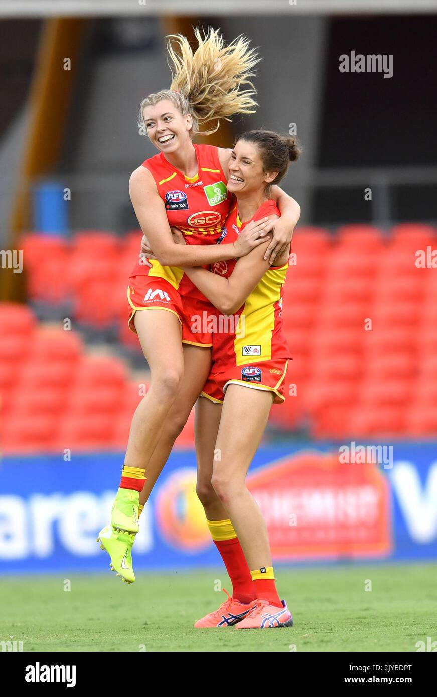 Kalinda Howarth (left) of the Suns celebrates kicking a goal during the ...