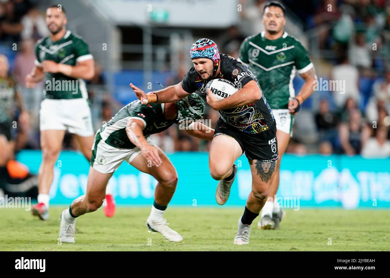 Josh Curran of the Indigenous All Stars runs in to score his sides ...