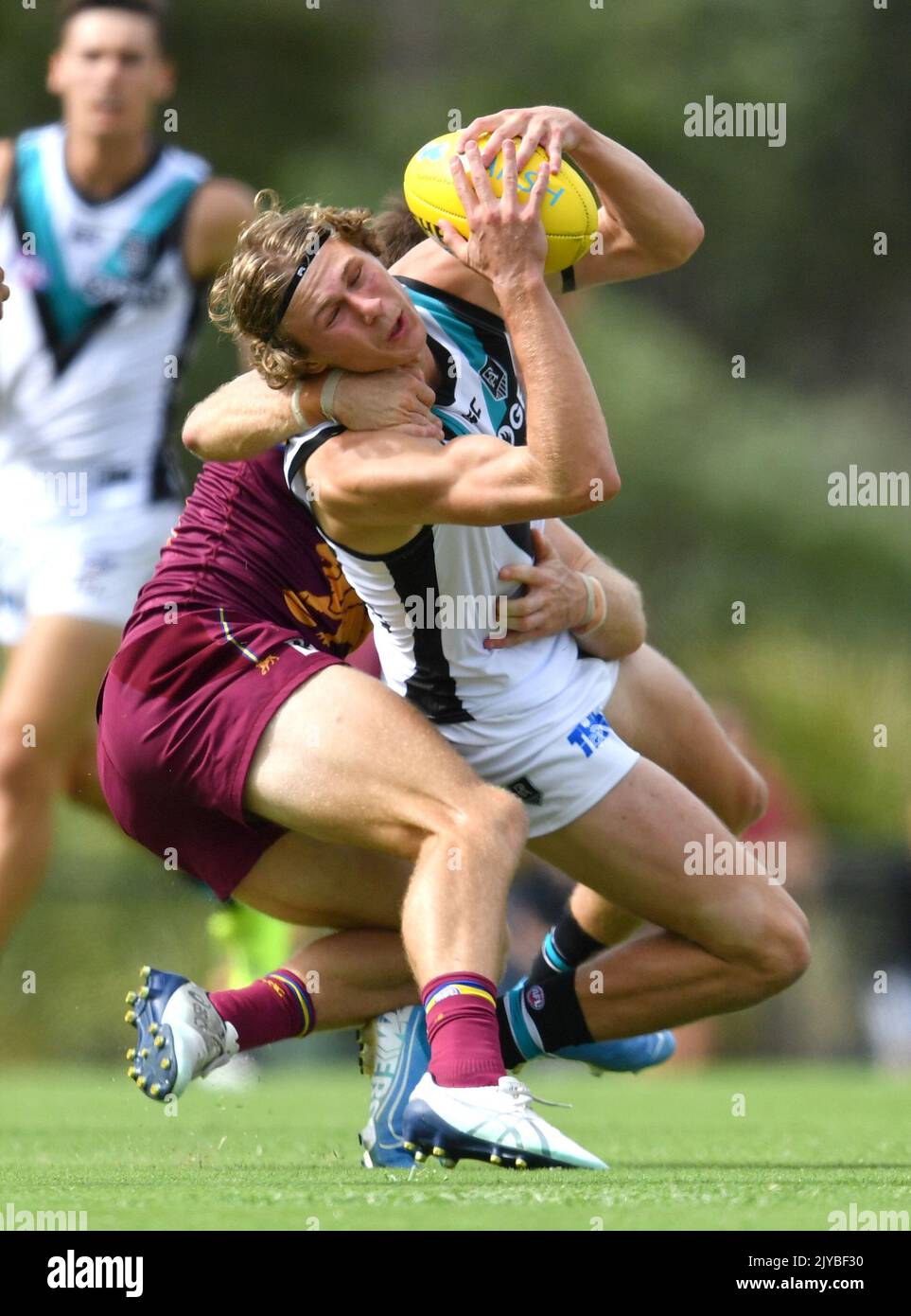 Xavier Duursma (right) of the Power is tackled high by Lincoln McCarthy ...