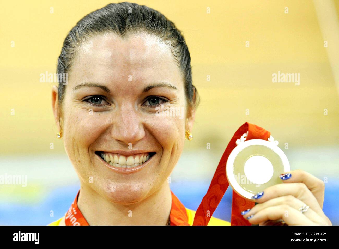 A teary-eyed Anna Meares proudly holds the silver medal she won in the ...