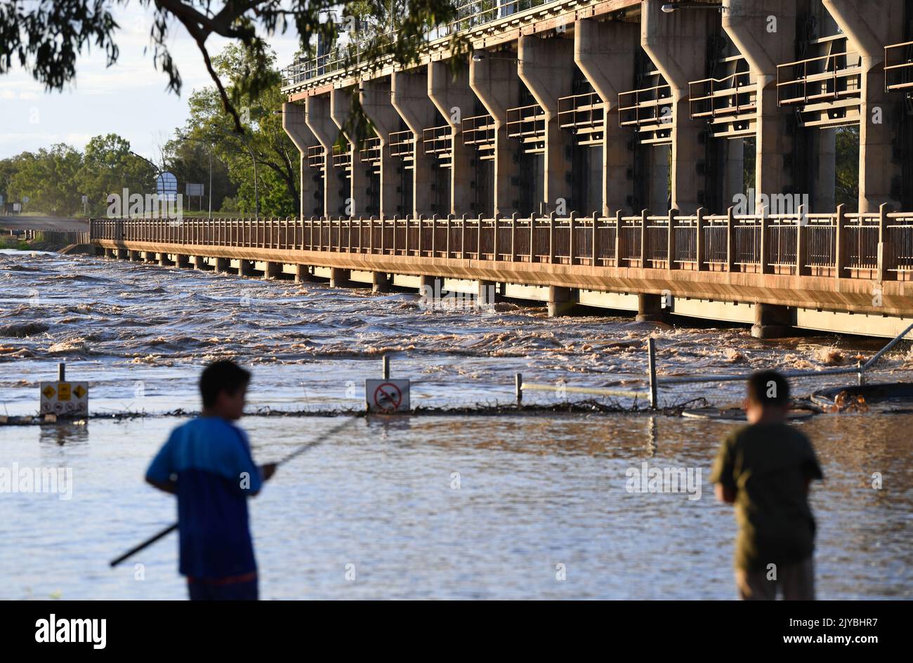 The swollen Balonne river gushes under the Jack Taylor weir in St ...