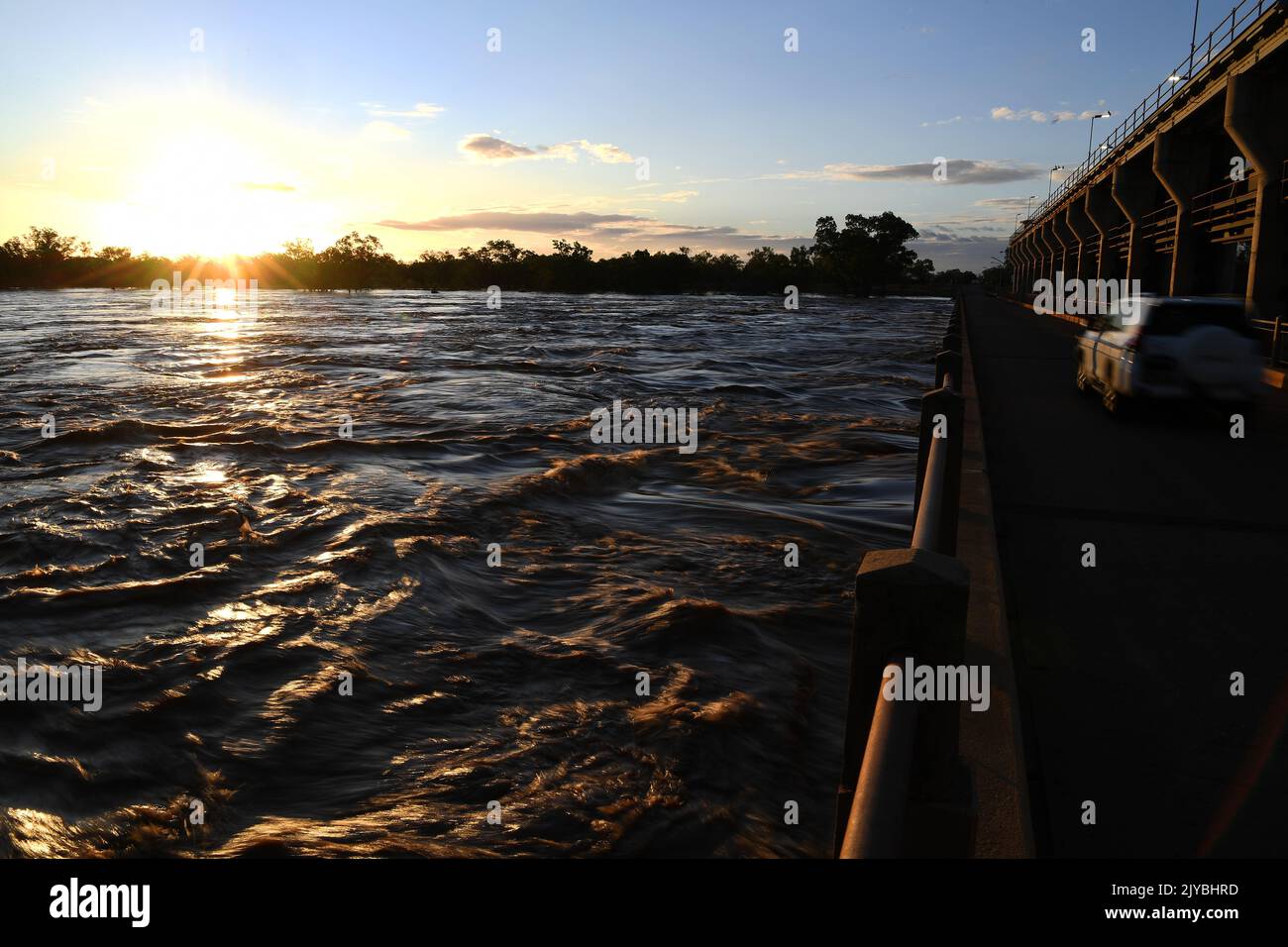 The swollen Balonne river gushes under the Jack Taylor weir in St ...