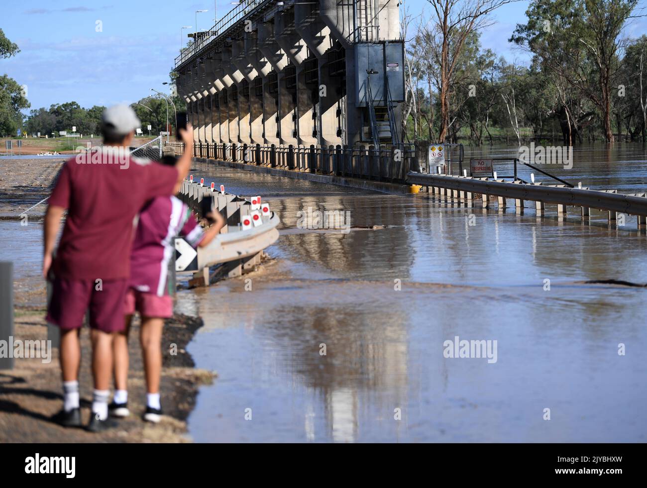 Locals take photos as water from the swollen Balonne river begin to ...