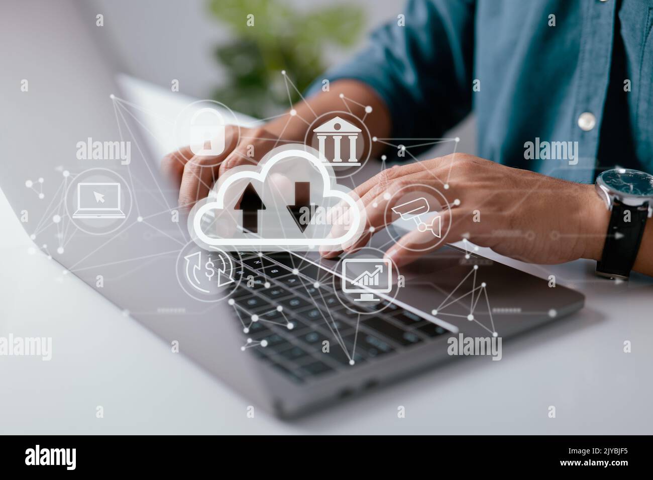 A man uses a laptop with a cloud computing diagram shown on hand. Cloud technology Data storage ...