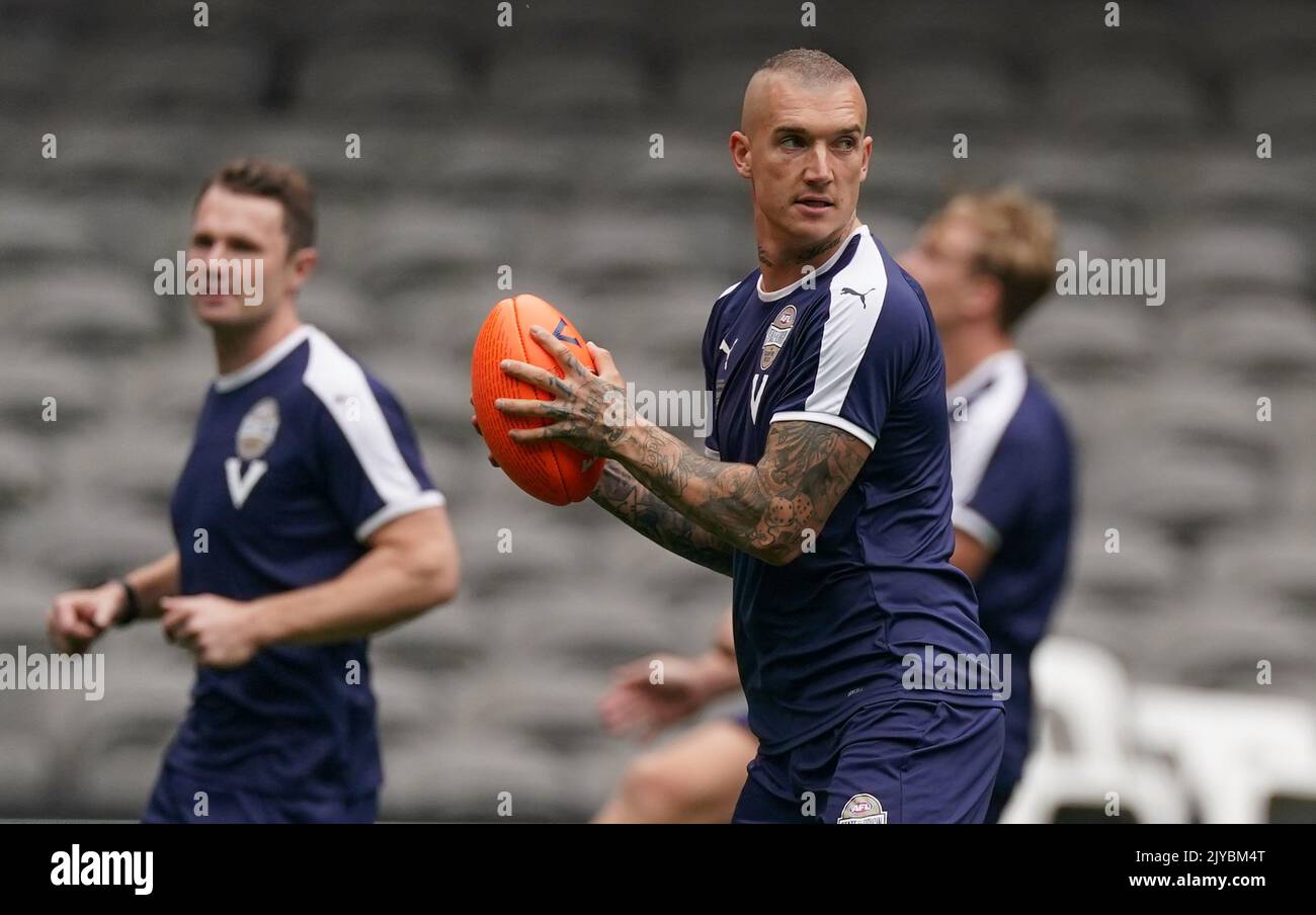 Dustin Martin of Victoria runs with the ball as Patrick Dangerfield ...