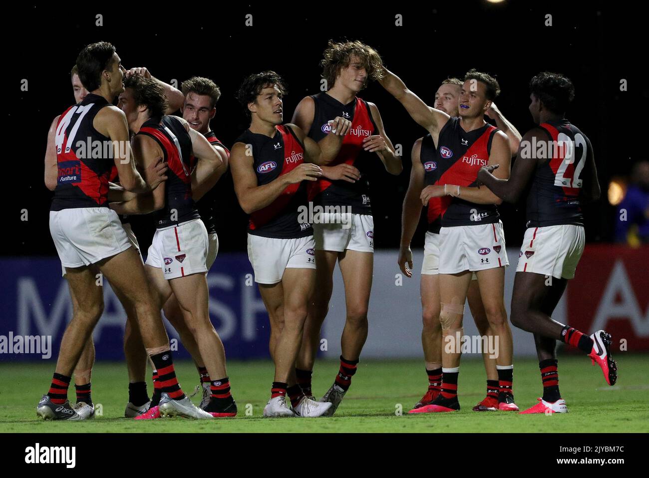 Harrison Jones of the Bombers is congratulated by teammates after ...