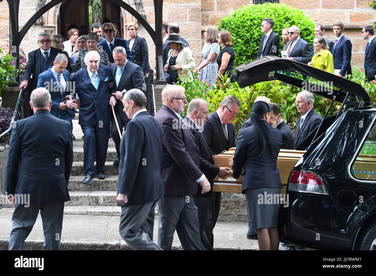 The casket of Caroline Laws is loaded into a hearse as John Laws leaves ...