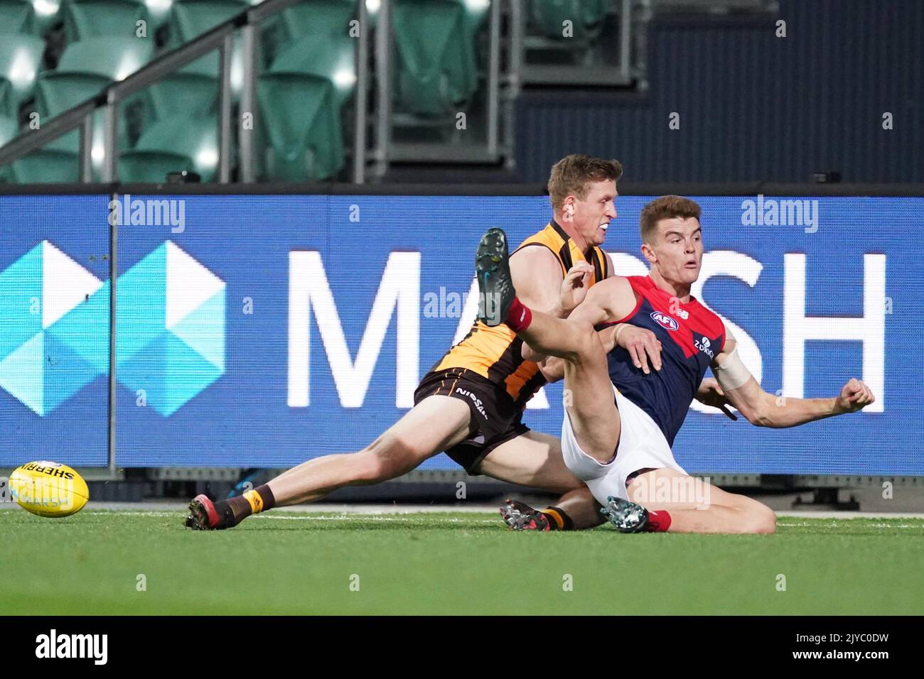 Sam Frost sling tackles Bayley Fritsch of the Demons during the AFL ...