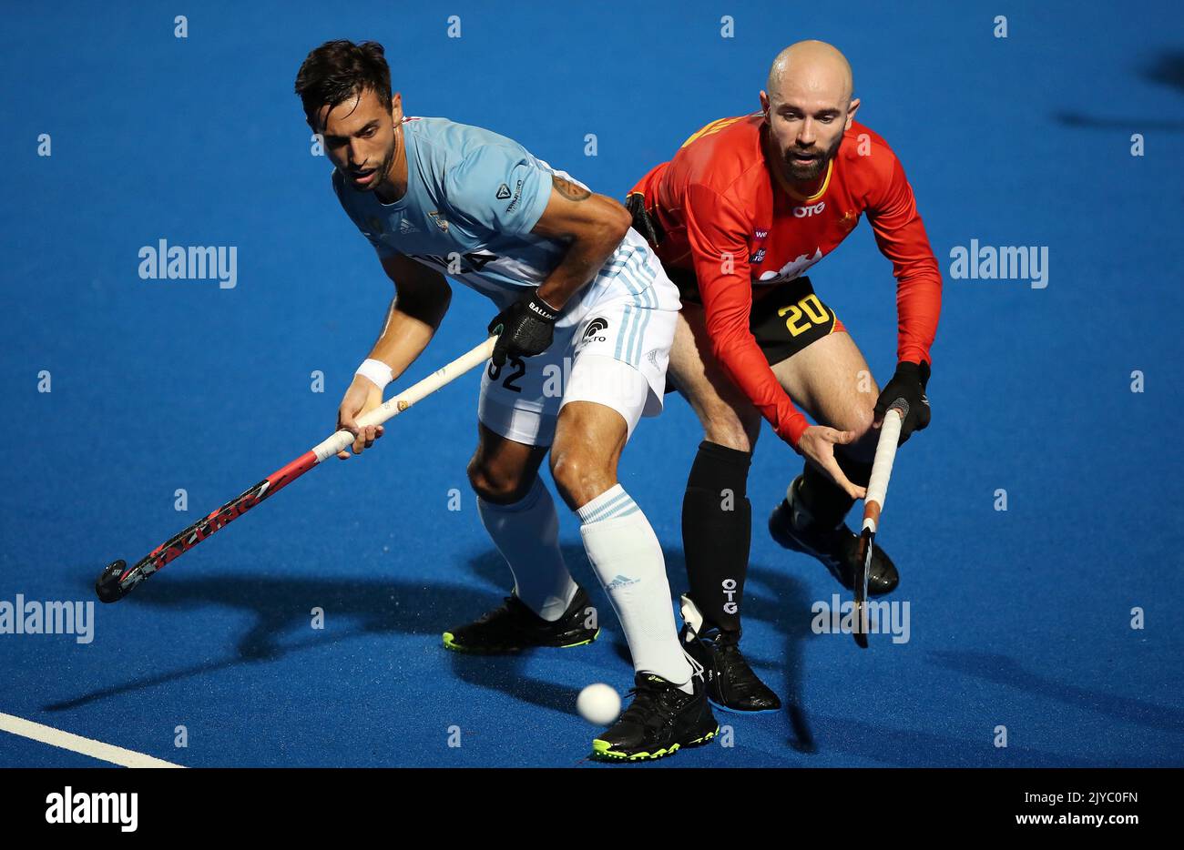 Matthew Swann of the Kookaburras battles for the ball with Martin ...