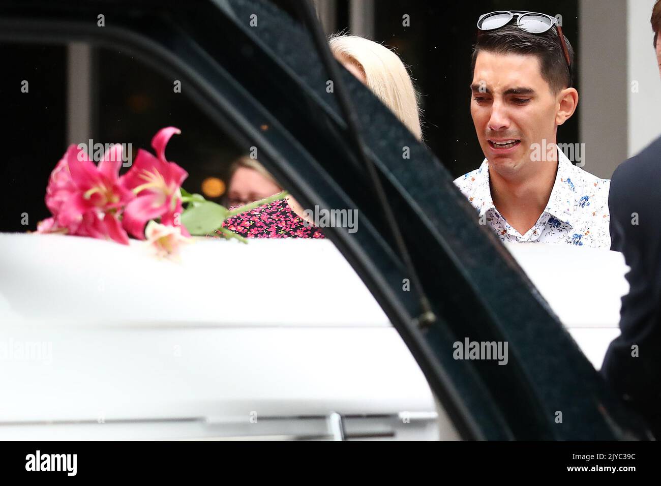 Nathaniel Clarke, brother to Hannah Clarke, looks on as the coffin is ...