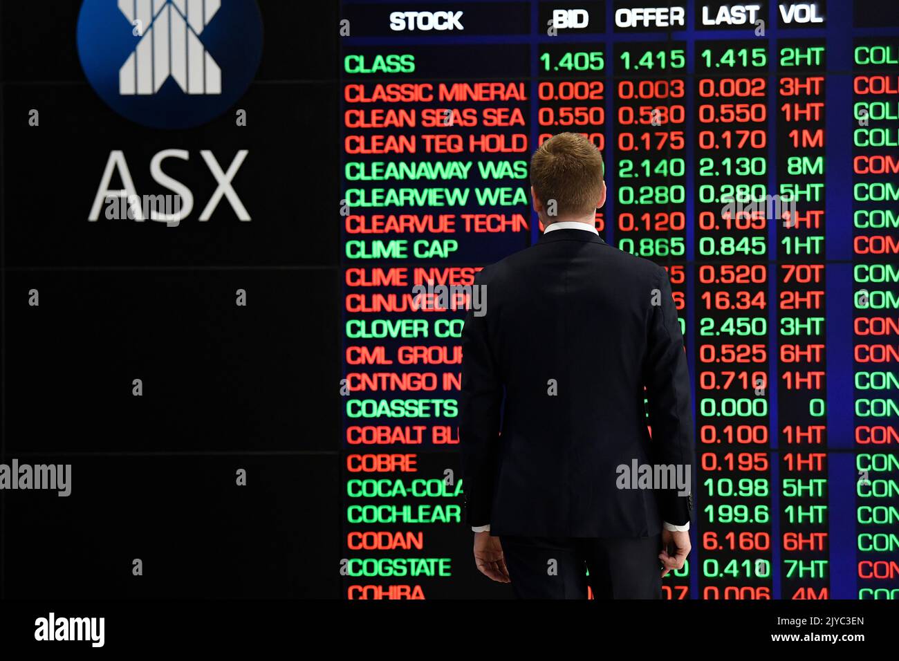 A man is seen looking at the digital market boards at the Australian Stock Exchange (ASX) in ...