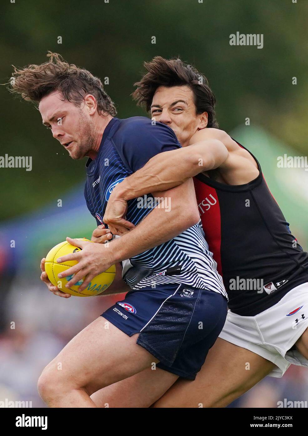 Dylan Shiel of the Bombers tackles Jack Steven of the Cats during the ...